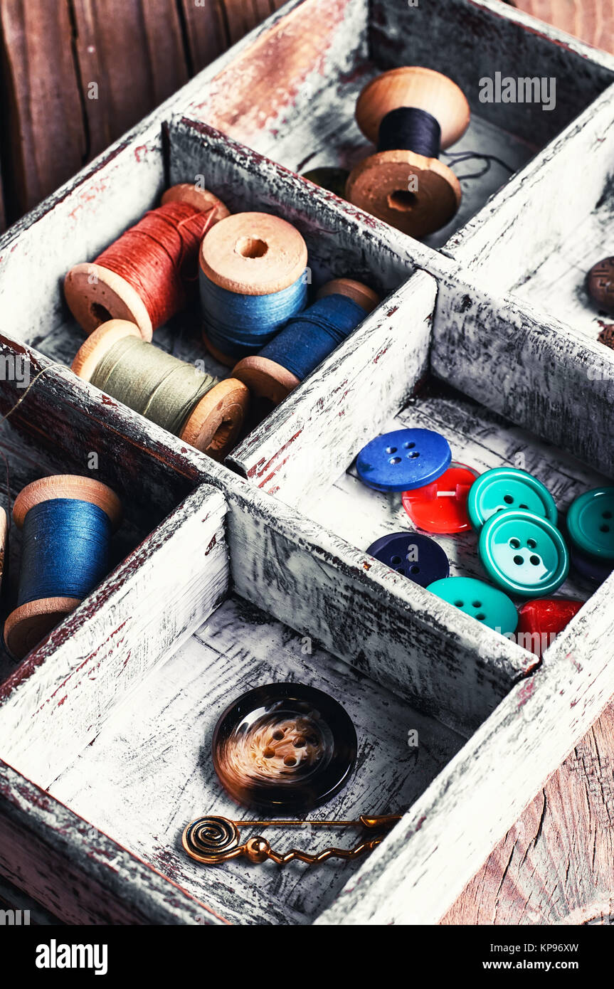 Wooden box with reels of sewing threads and buttons Stock Photo - Alamy