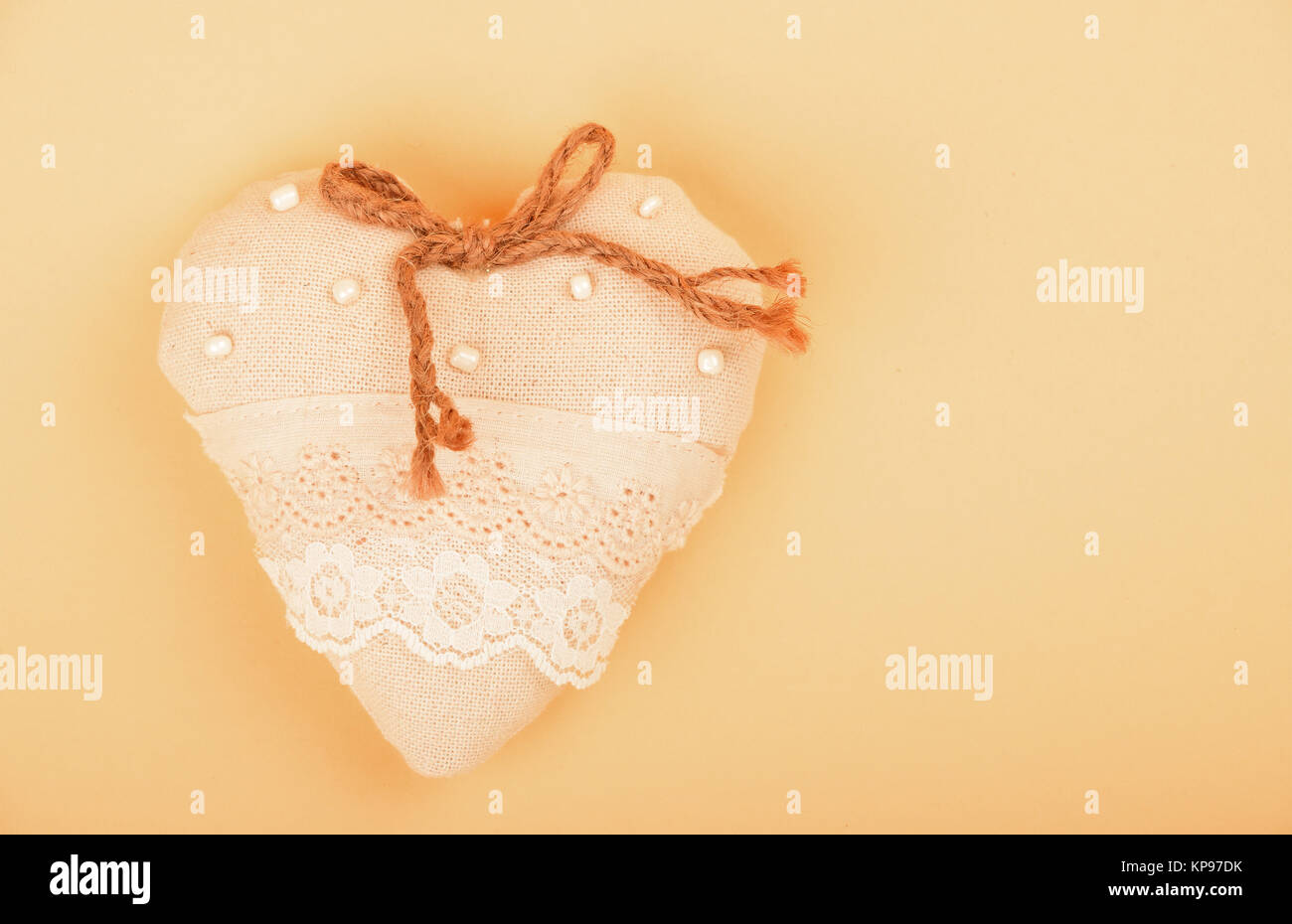 Beige toy textile lace heart with bow with copy space Stock Photo - Alamy