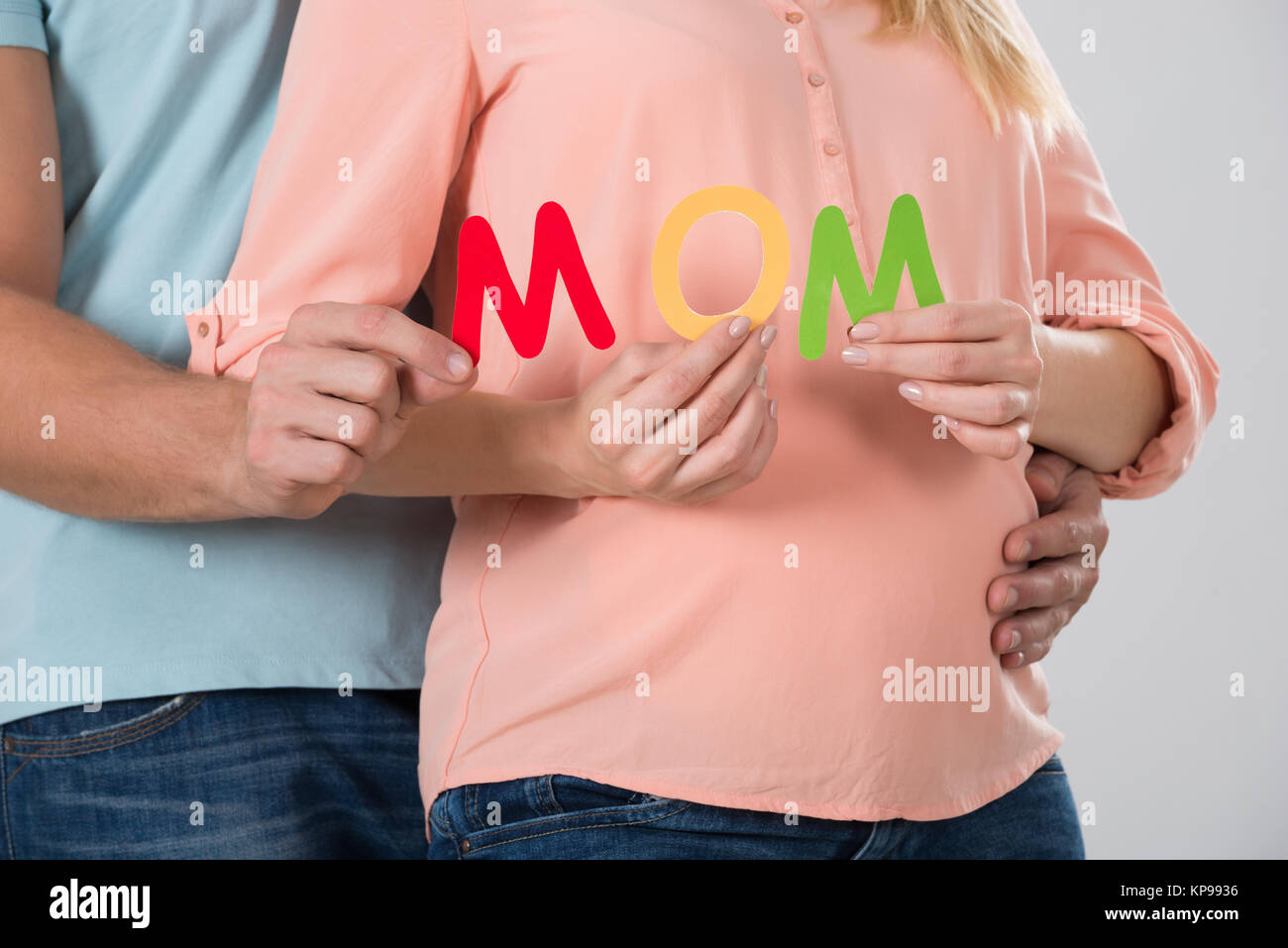 Expecting Couple Holding Word Mom Stock Photo - Alamy