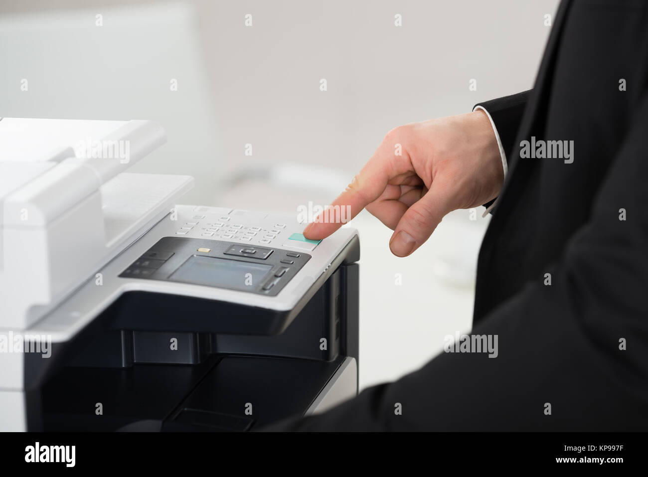 Businessman Operating Printer In Office Stock Photo - Alamy