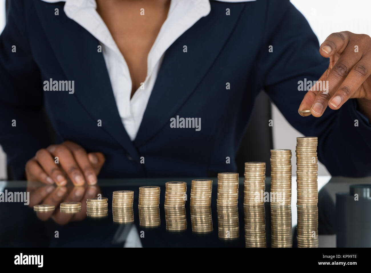 Person's Hand Making Stack Of Coins Stock Photo - Alamy