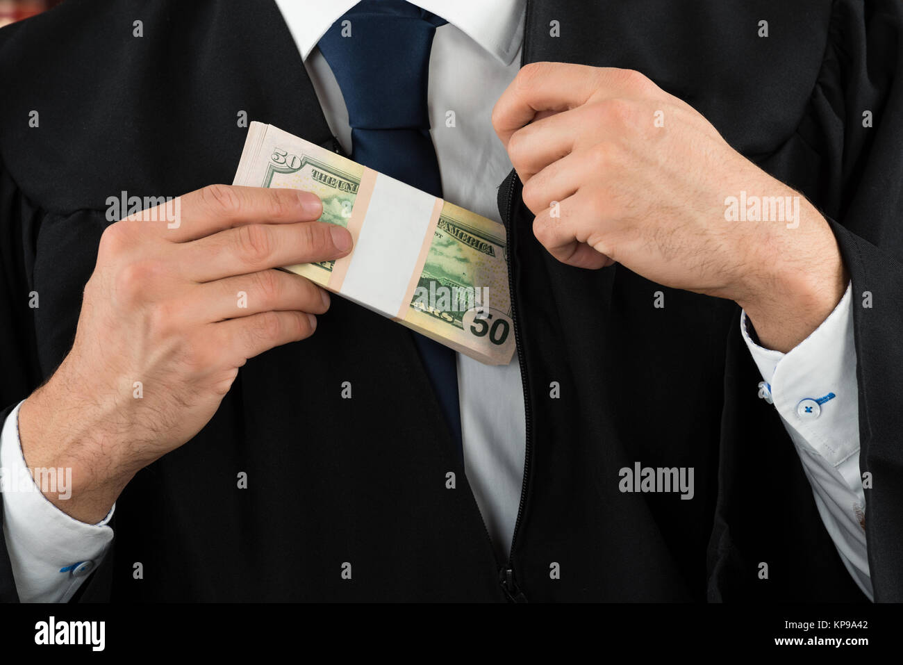 Judge Putting Dollar Bundle In Pocket Stock Photo - Alamy