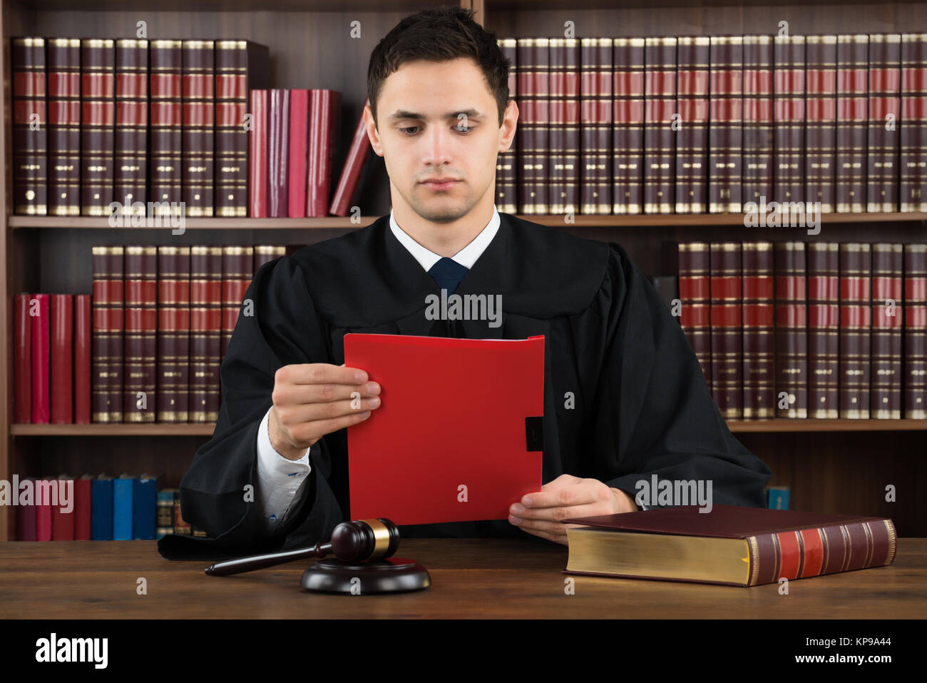 Judge Reading Legal Document At Desk Stock Photo - Alamy