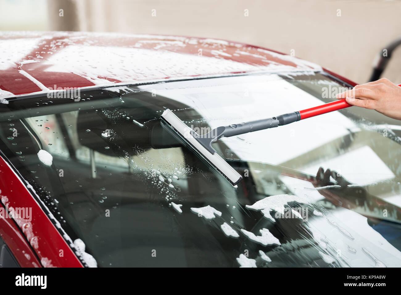 Worker Washing Windshield Of Car At Service Station Stock Photo - Alamy