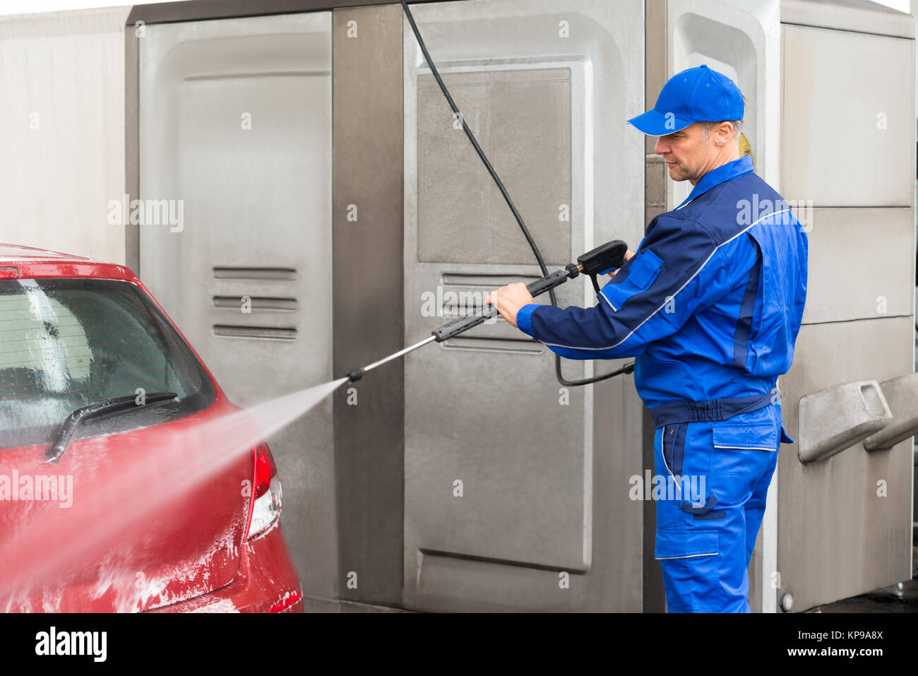Serviceman With High Pressure Water Jet Washing Car Stock Photo - Alamy