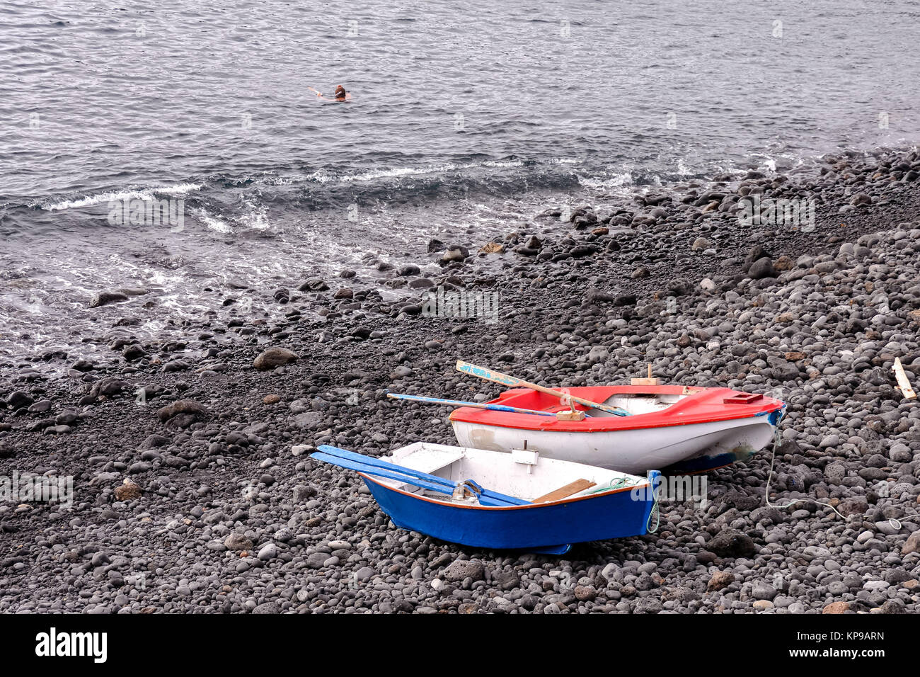 Photo Picture of a Colored Boat Near the Ocean Coast Stock Photo - Alamy