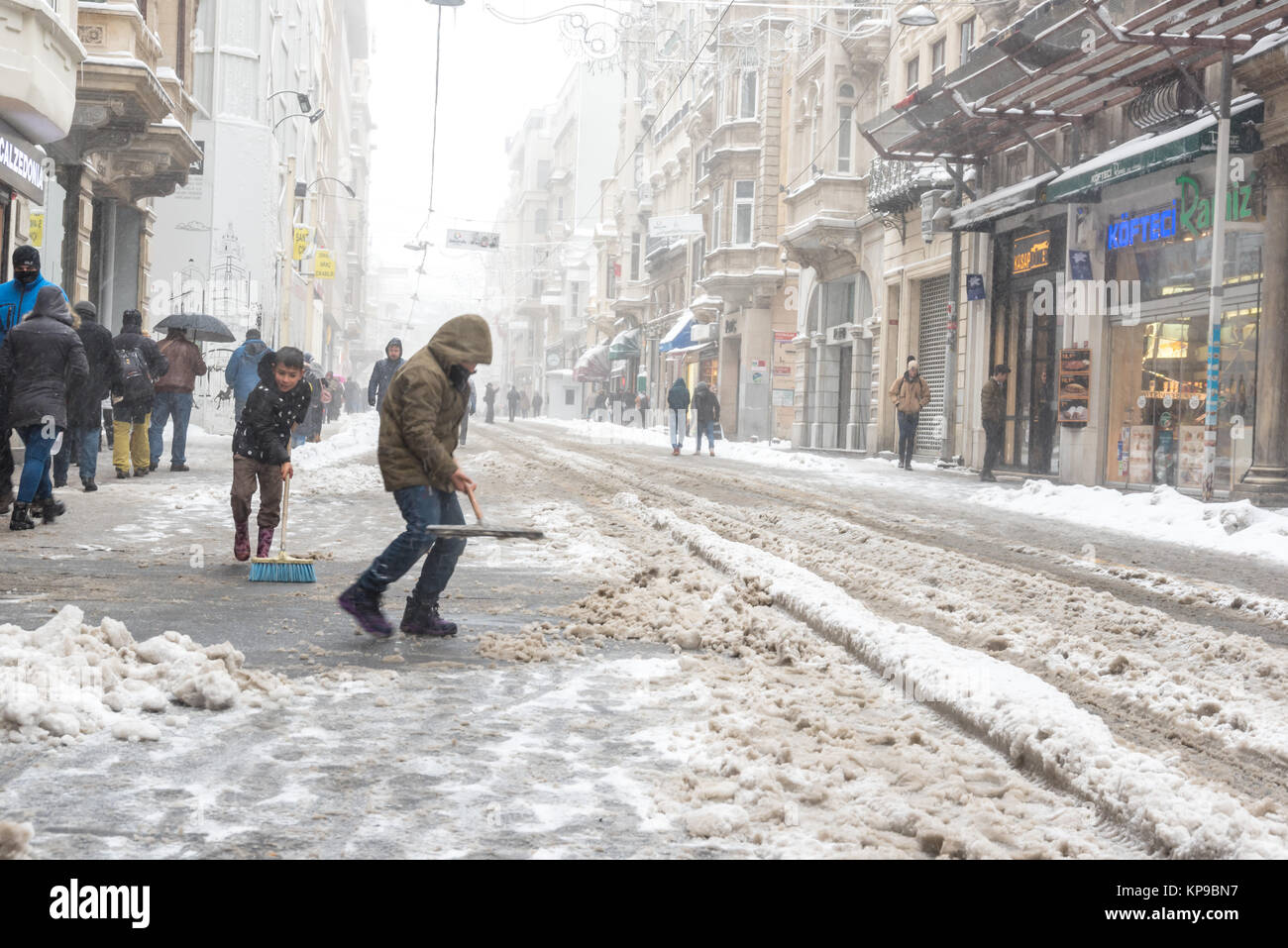 Children cleaning snow of popular Istiklal Street of Beyoglu,Istanbul ...