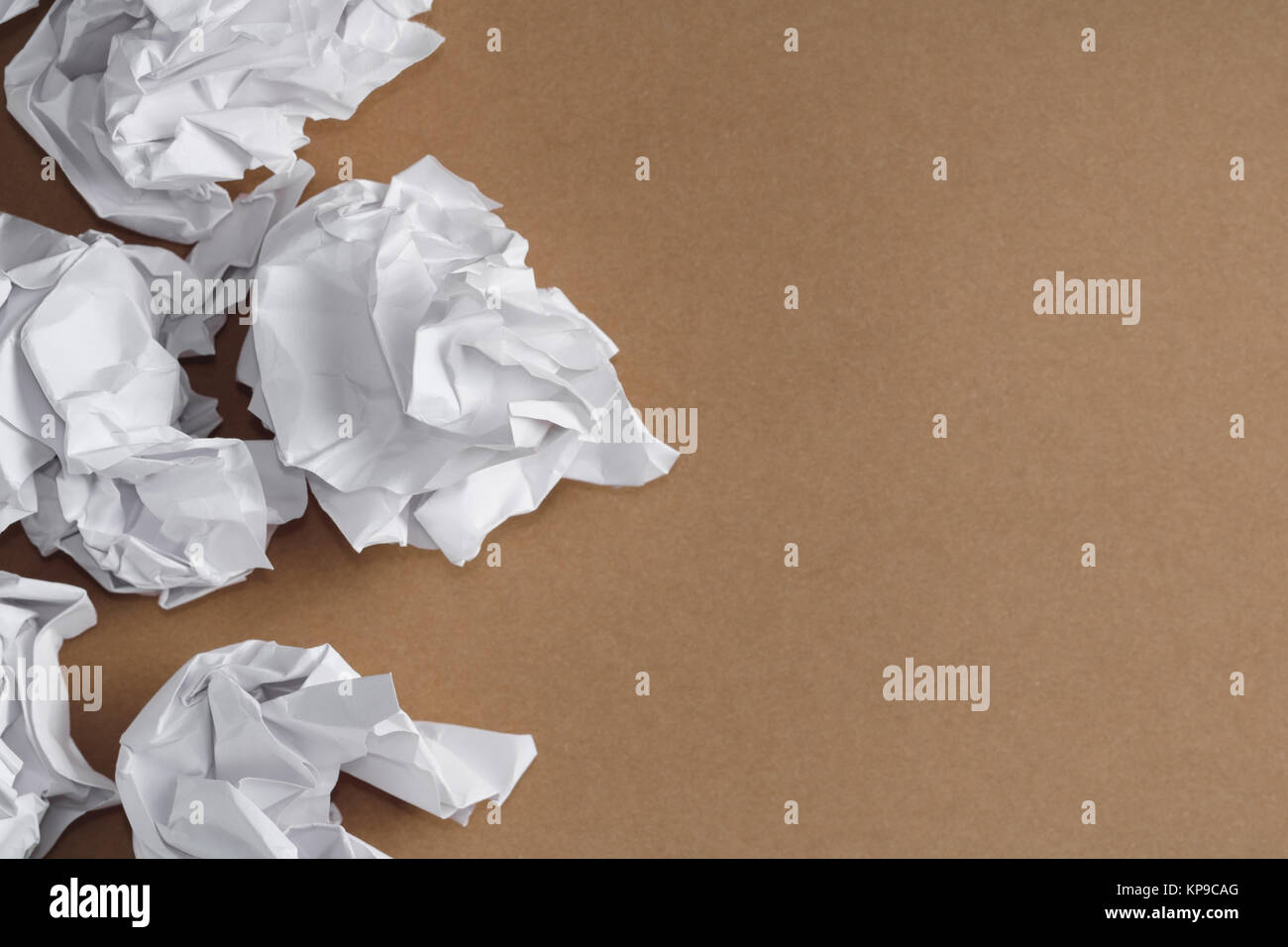 Top view of balls of crumpled white paper on a kraft background Stock ...