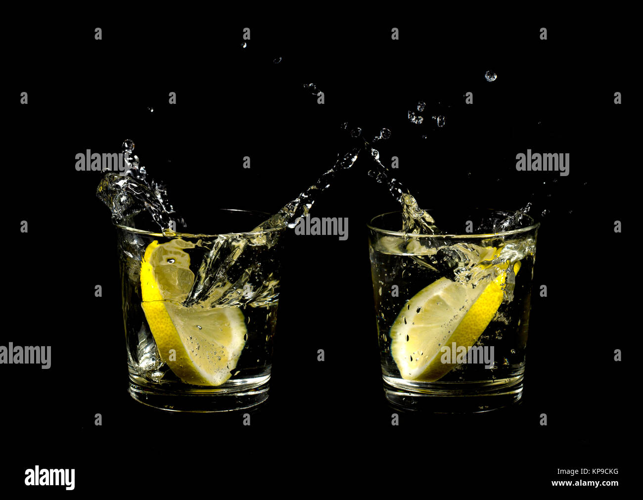 lemons splashing in two glasses Stock Photo - Alamy