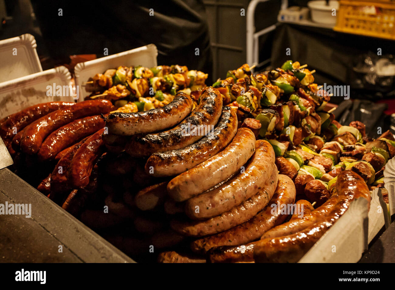 Meat sausages and skewers on street barbecue grill Stock Photo - Alamy