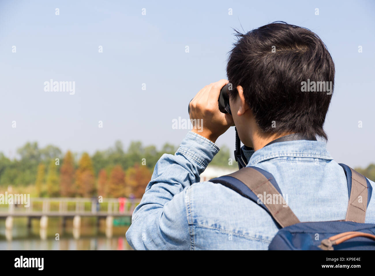 Chinese man using binoculars hi-res stock photography and images - Alamy