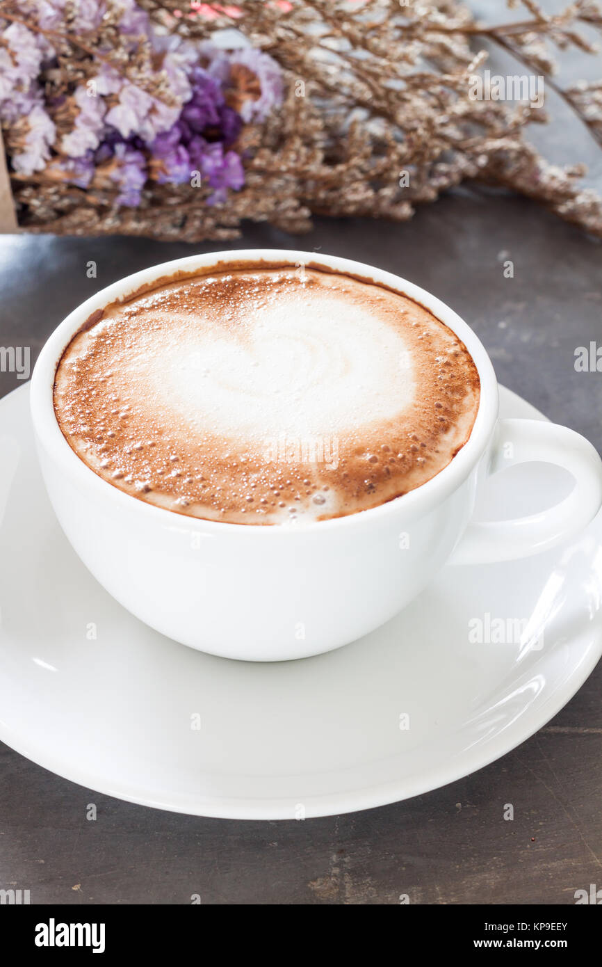 Coffee cup with beautiful violet flower Stock Photo - Alamy