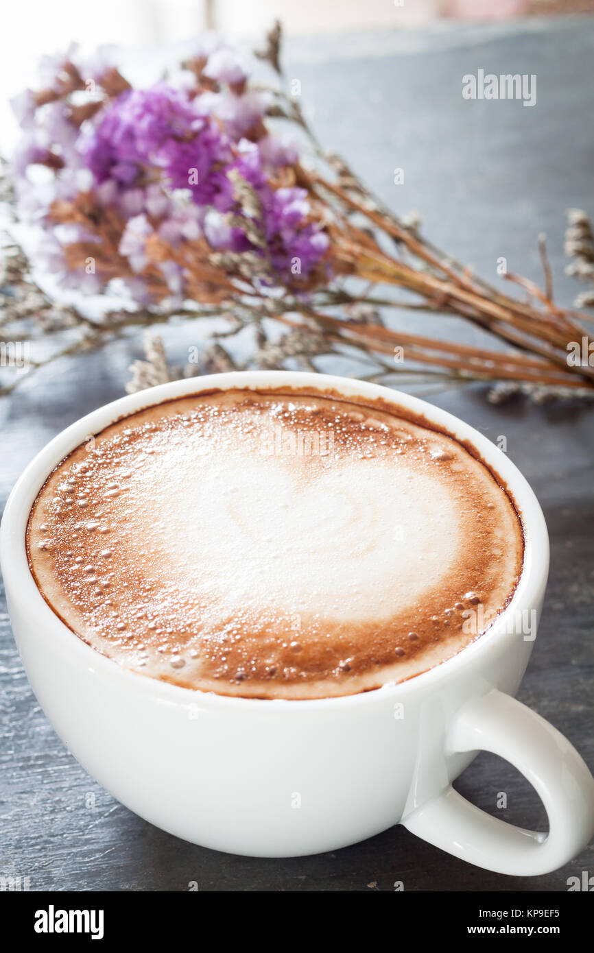 Coffee cup with beautiful violet flower Stock Photo - Alamy