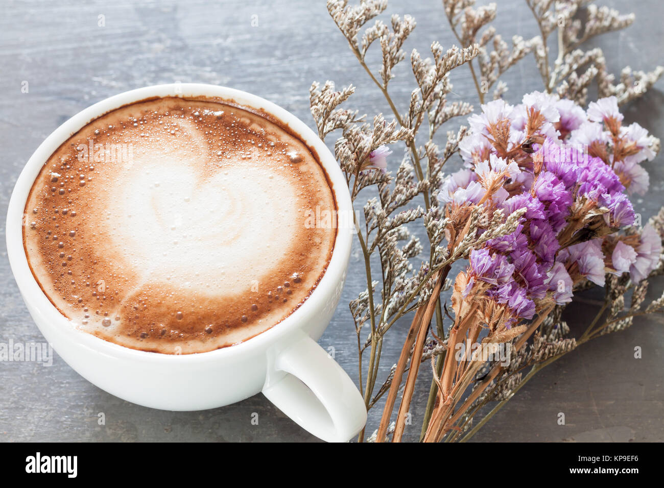 Coffee cup with beautiful violet flower Stock Photo - Alamy