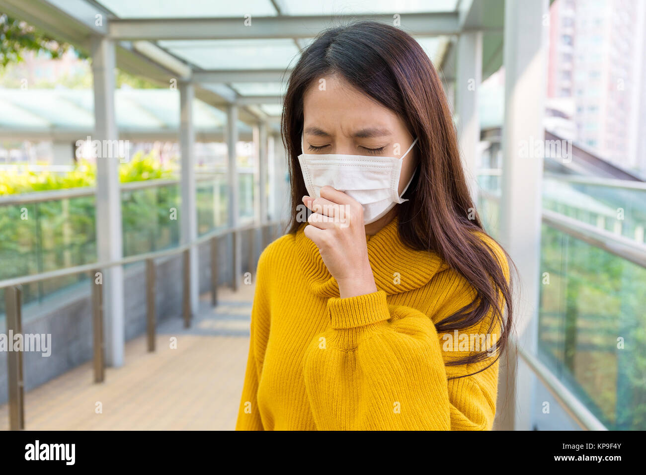 Asian woman coughing Stock Photo - Alamy