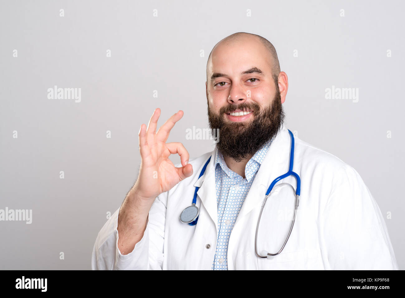 young bearded doctor in white coat- all right Stock Photo - Alamy