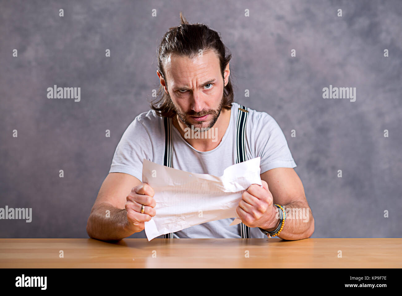 young man is annoyed about a letter Stock Photo - Alamy