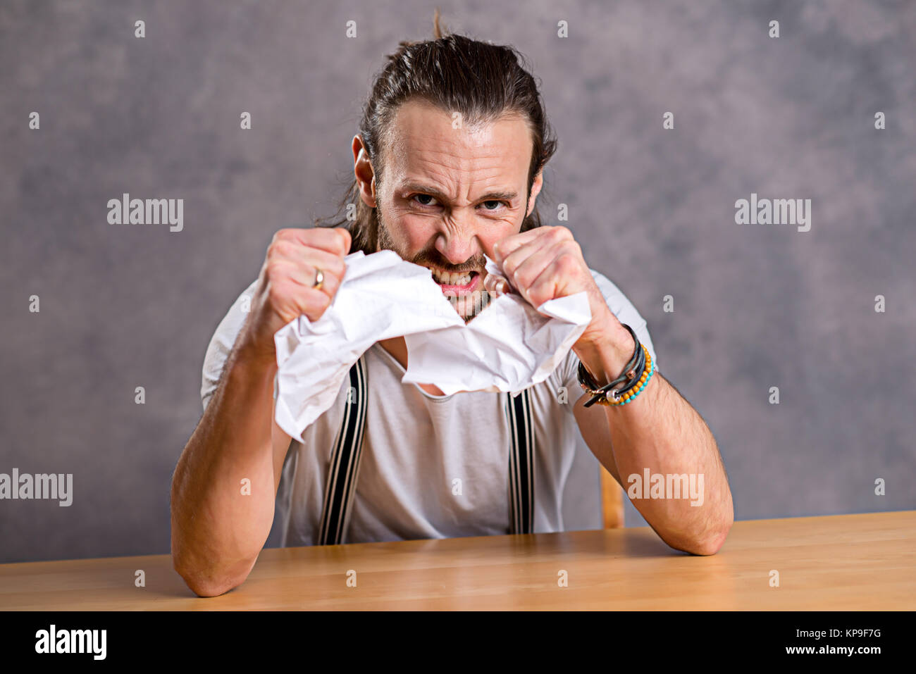 young man is annoyed about a letter Stock Photo - Alamy