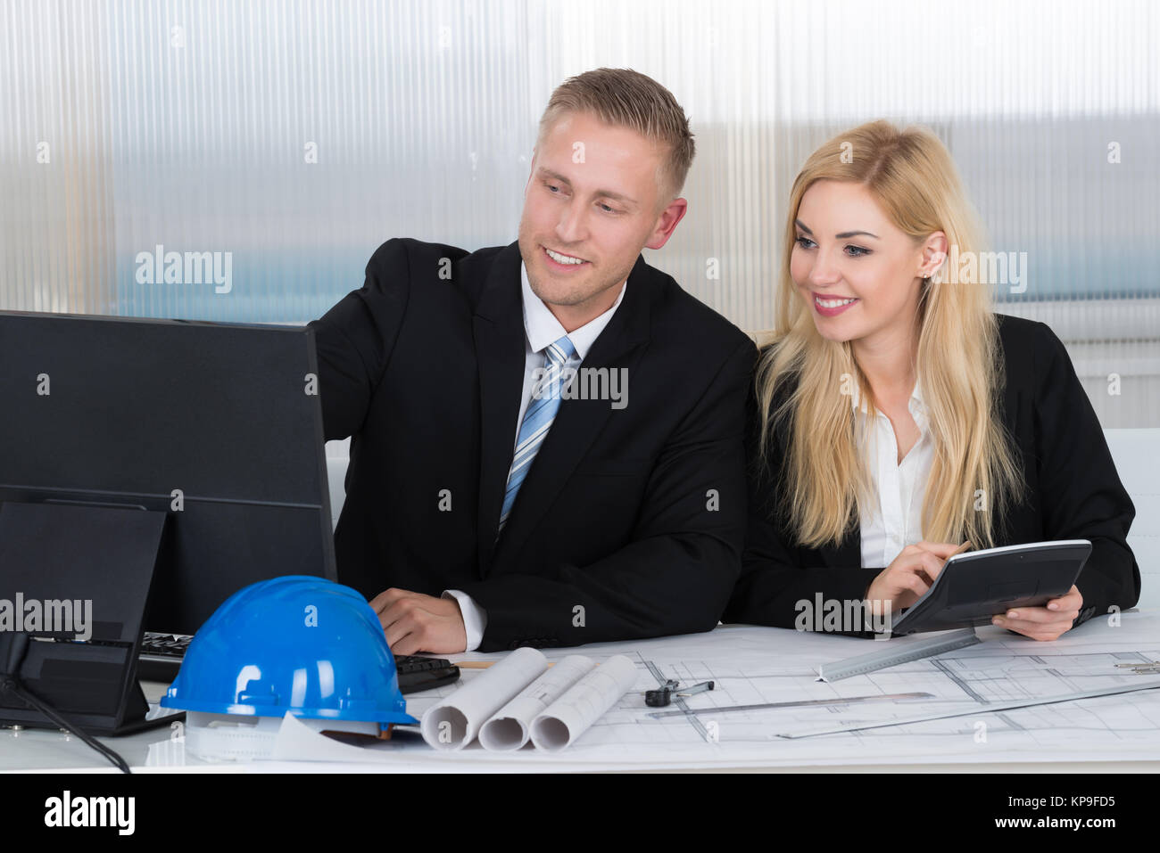 Architects Discussing Over Computer In Office Stock Photo - Alamy