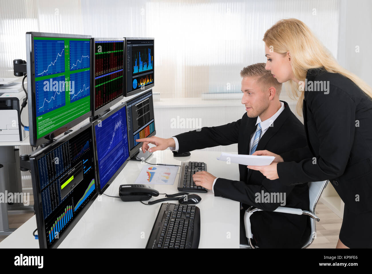 Financial Agents Monitoring Computer Screens In Office Stock Photo - Alamy