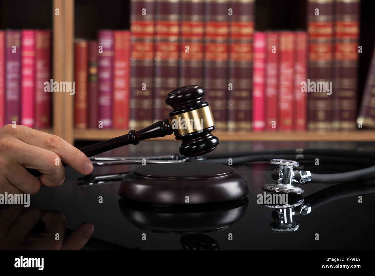 Judge Striking The Gavel At Table Against Bookshelf Stock Photo - Alamy