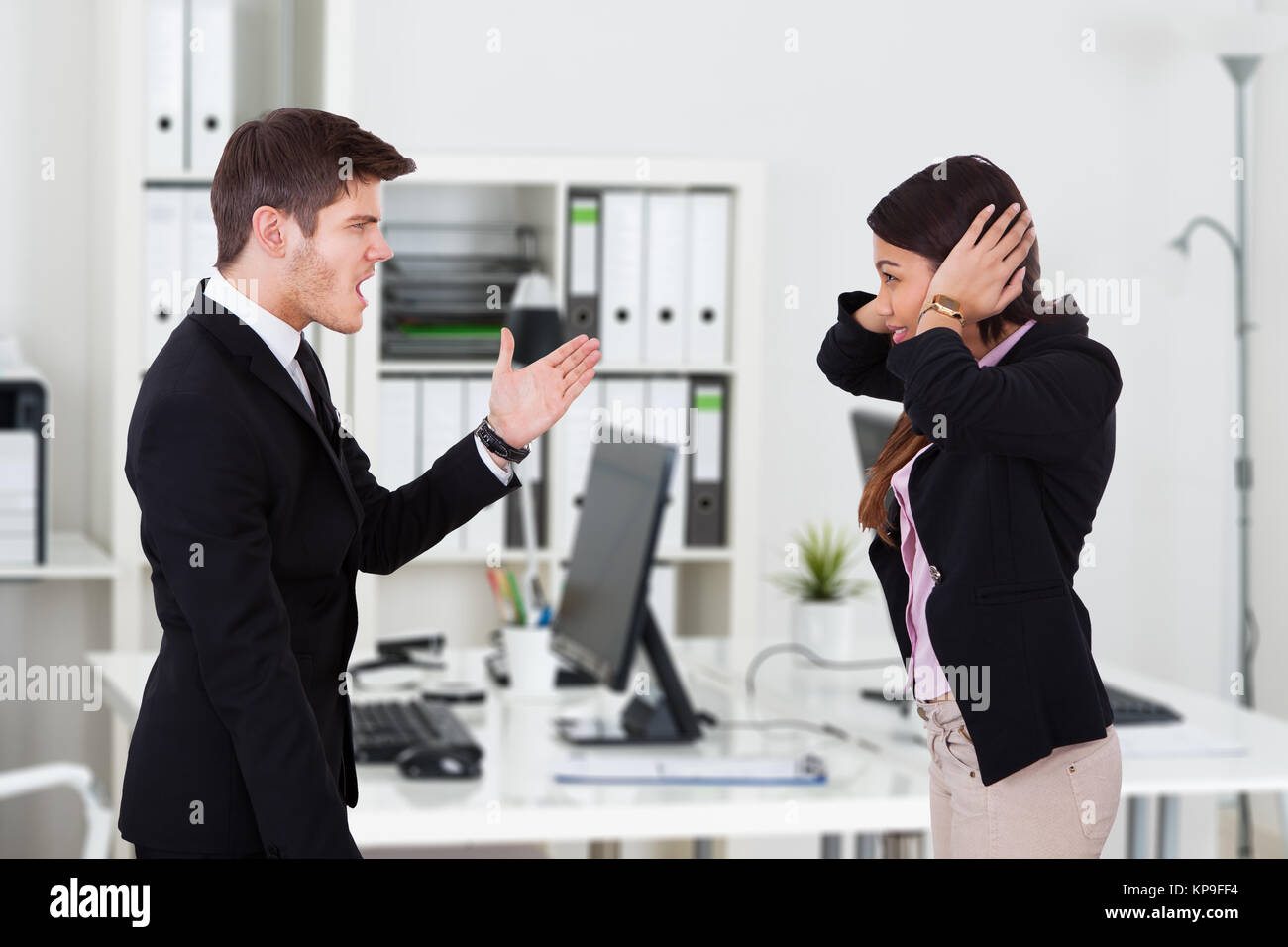 Boss Yelling At Secretary Covering Ears Stock Photo - Alamy