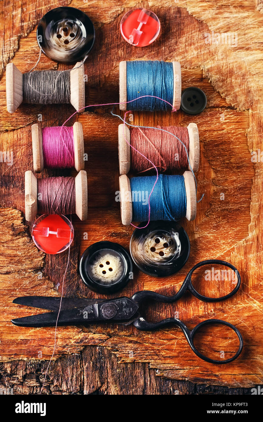 Six antiquated sewing thread and buttons on retro background Stock ...