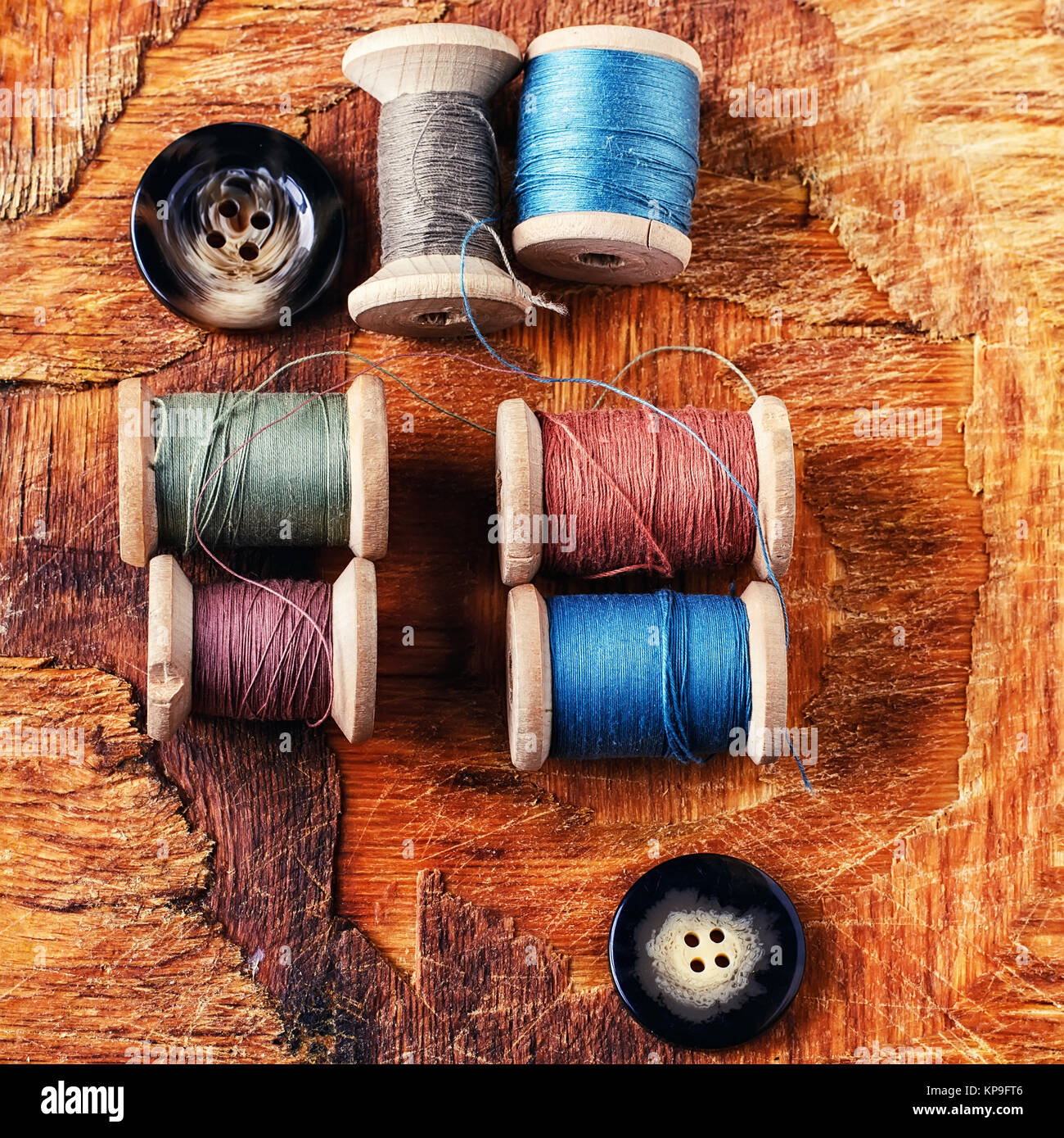 Six antiquated sewing thread and buttons on retro background Stock ...