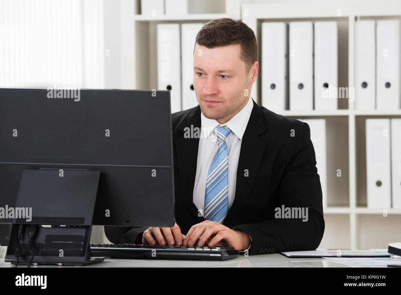 Businessman Using Computer In Office Stock Photo - Alamy