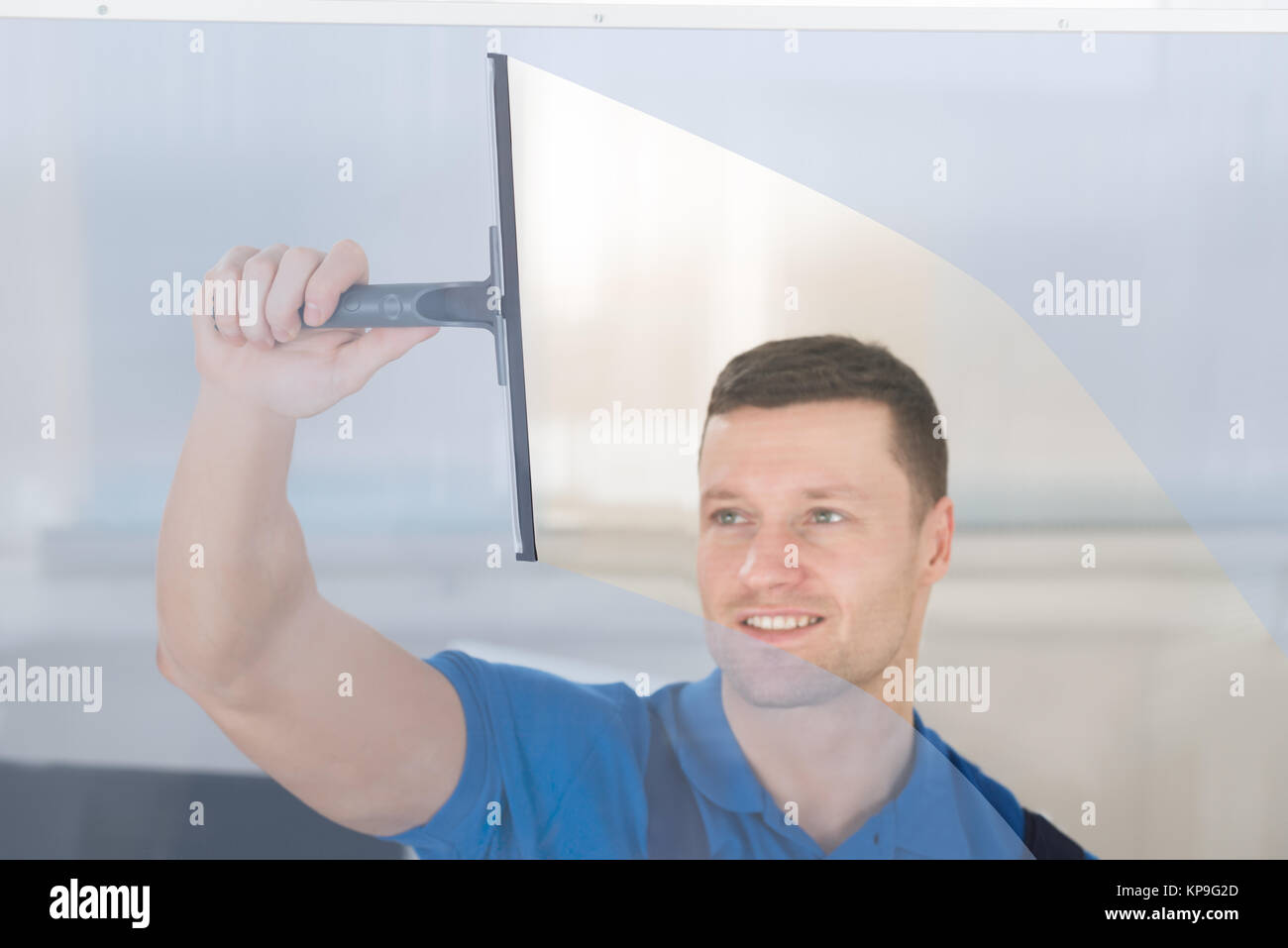 Worker Cleaning Glass Window With Squeegee Stock Photo - Alamy