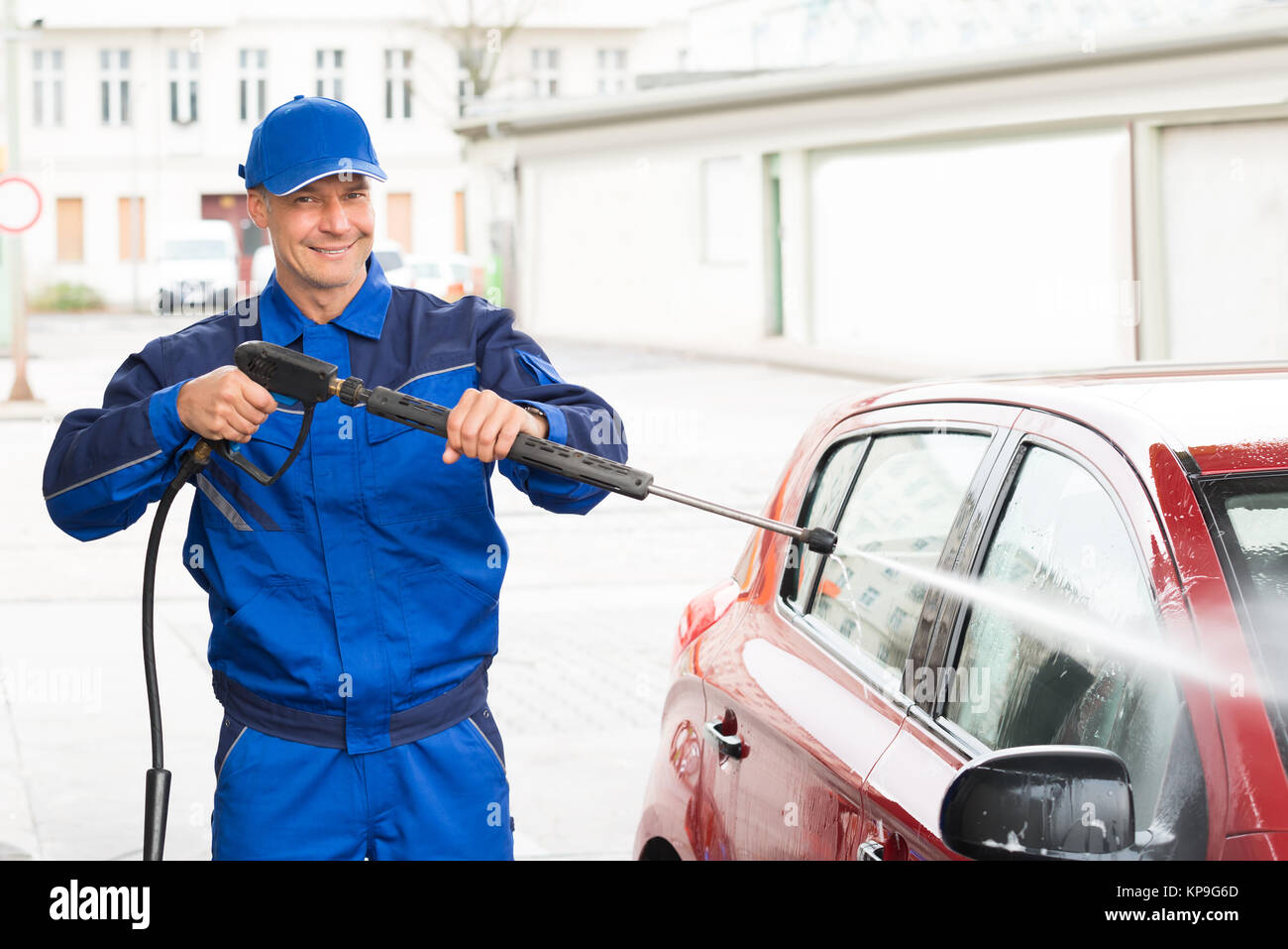 Serviceman With High Pressure Water Jet Washing Car Stock Photo - Alamy