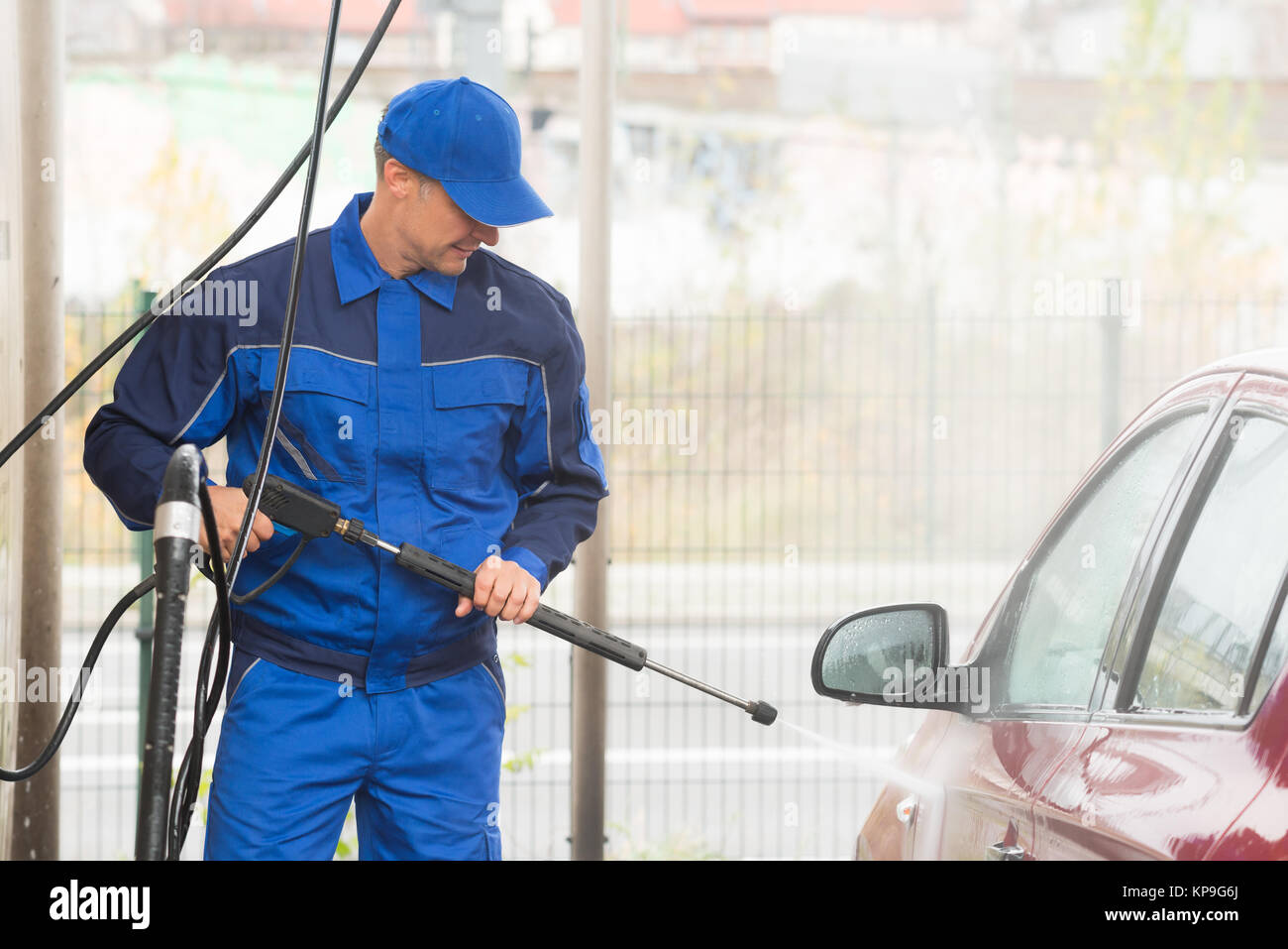 Serviceman With High Pressure Water Jet Washing Car Stock Photo - Alamy