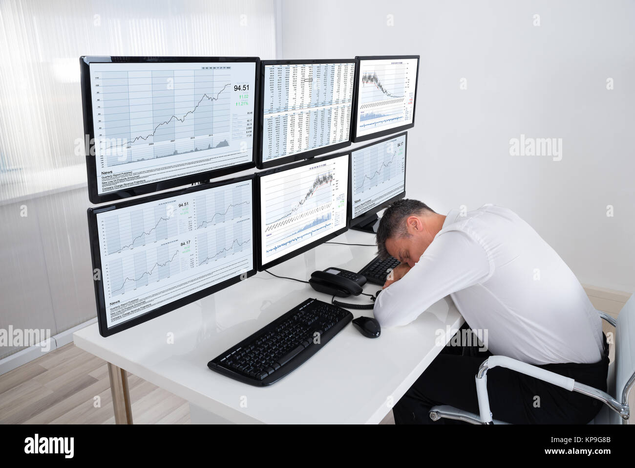 Stock Trader Sleeping At Multiple Computer's Desk Stock Photo - Alamy