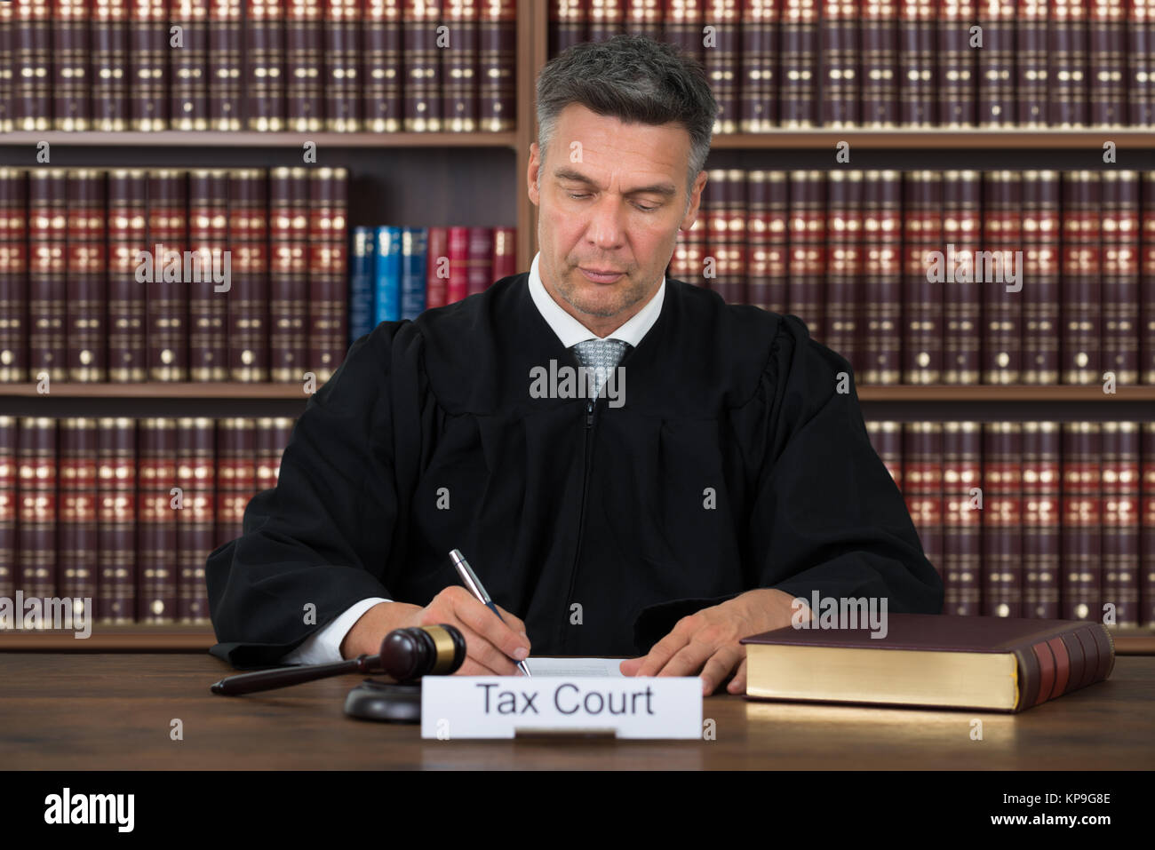 Tax Court Nameplate On Table With Judge Writing In Courtroom Stock ...
