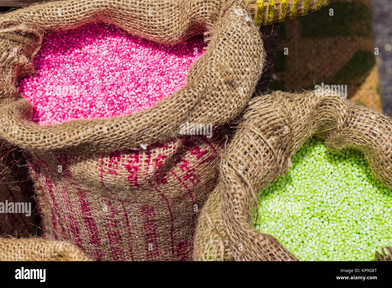 Sack of Dried tapioca pink and green on the wooden table background at ...