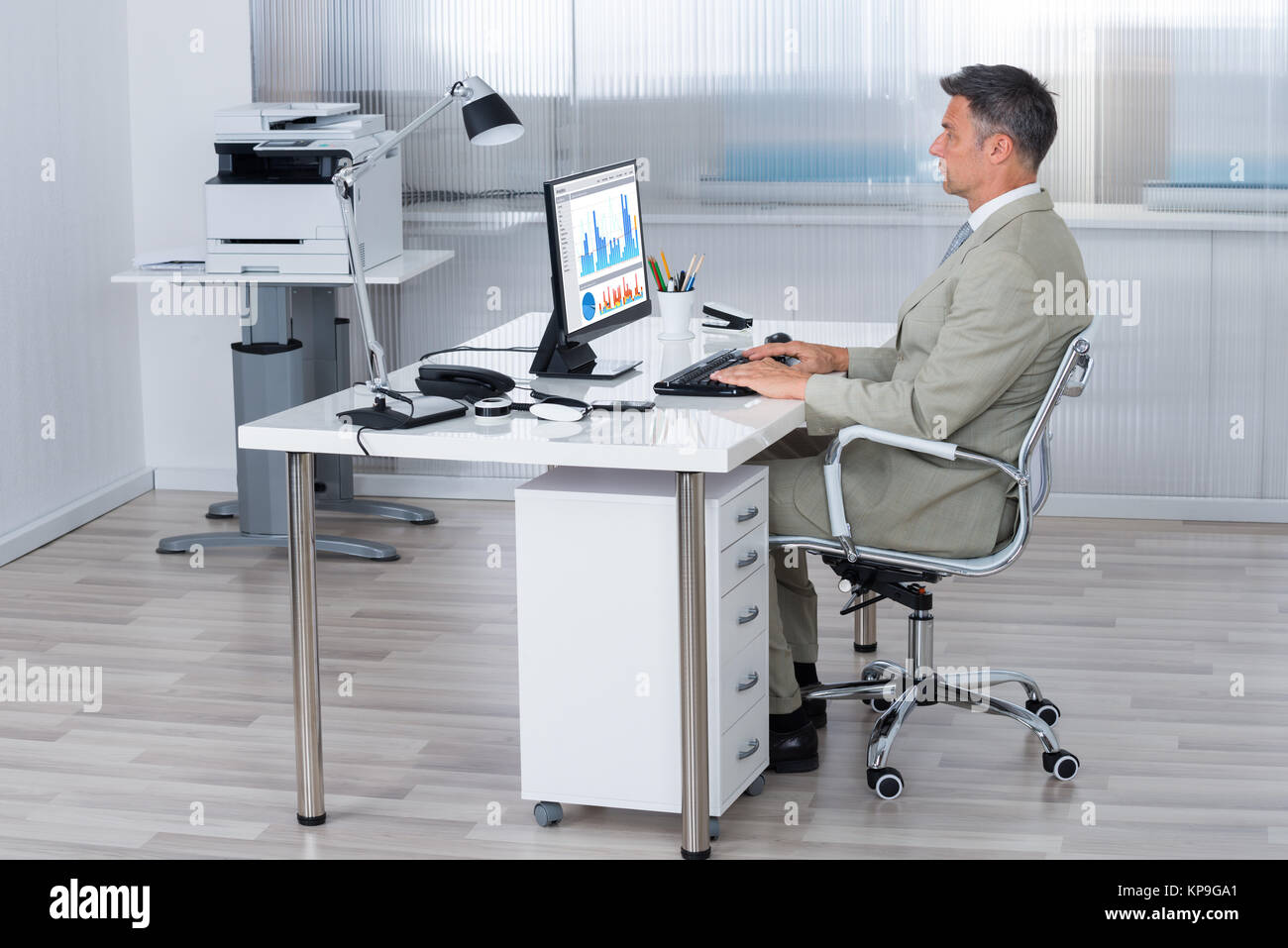 Businessman Using Computer At Desk In Office Stock Photo - Alamy