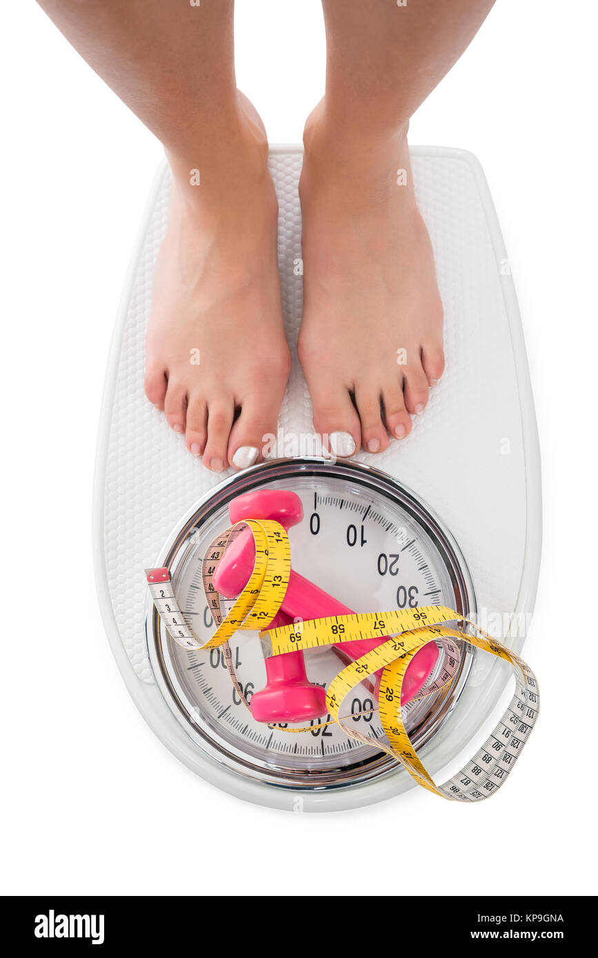 Woman Stepping On Weight Scale With Dumbbells And Tape Measure Stock ...