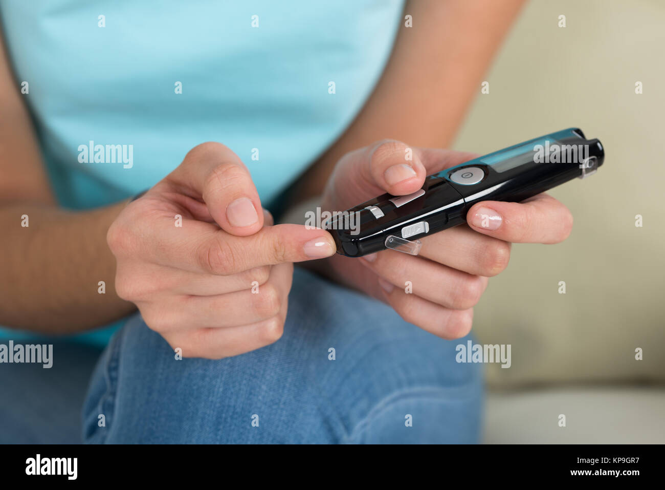 Woman Using Glucometer To Check Blood Sugar Level Stock Photo - Alamy