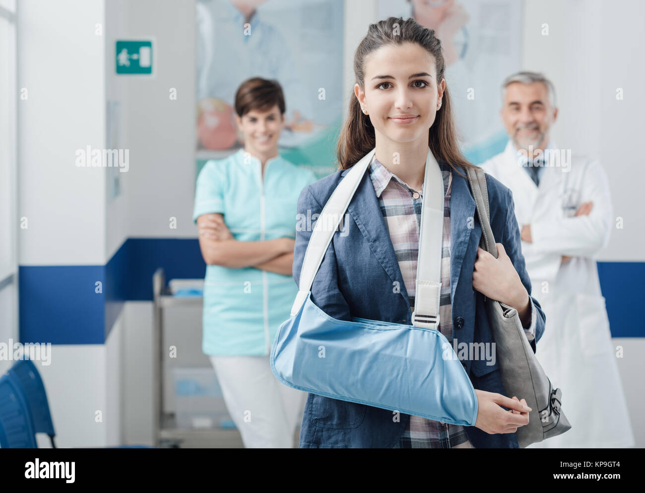 Professional medical team assisting a patient with broken arm at the ...