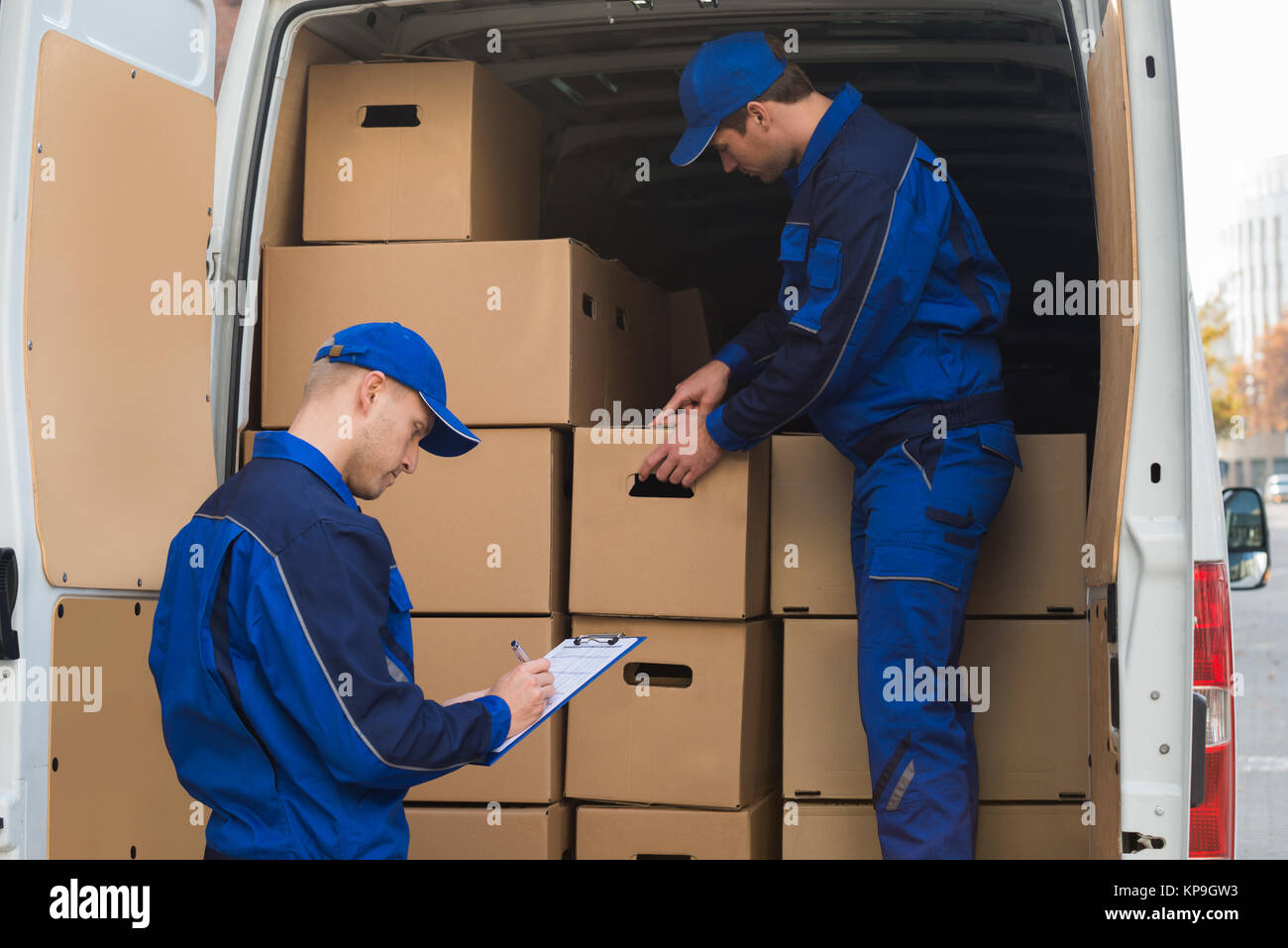 Delivery Men Unloading Boxes Stock Photo - Alamy