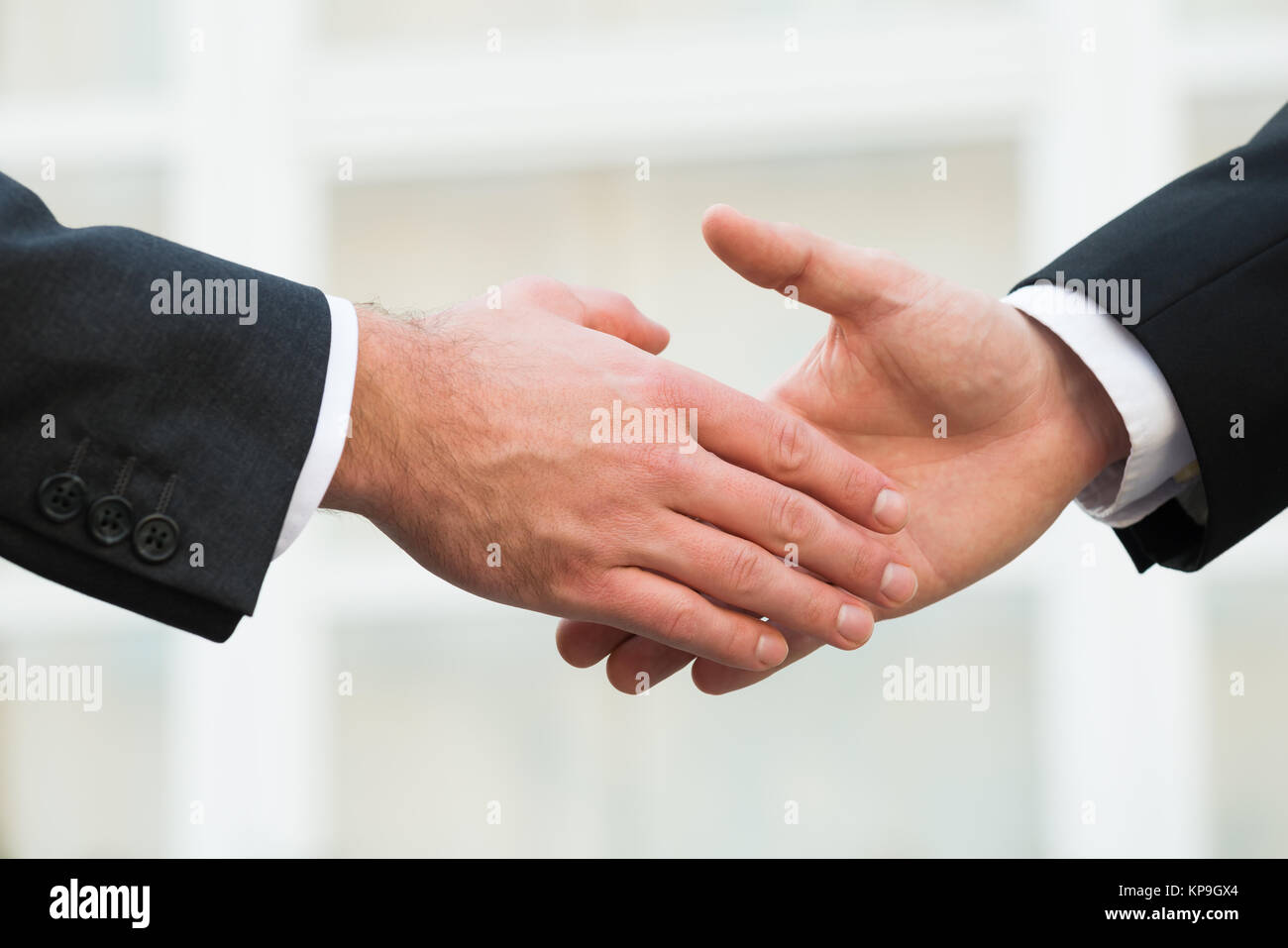 Businessman Shaking Hands With Partner Stock Photo - Alamy