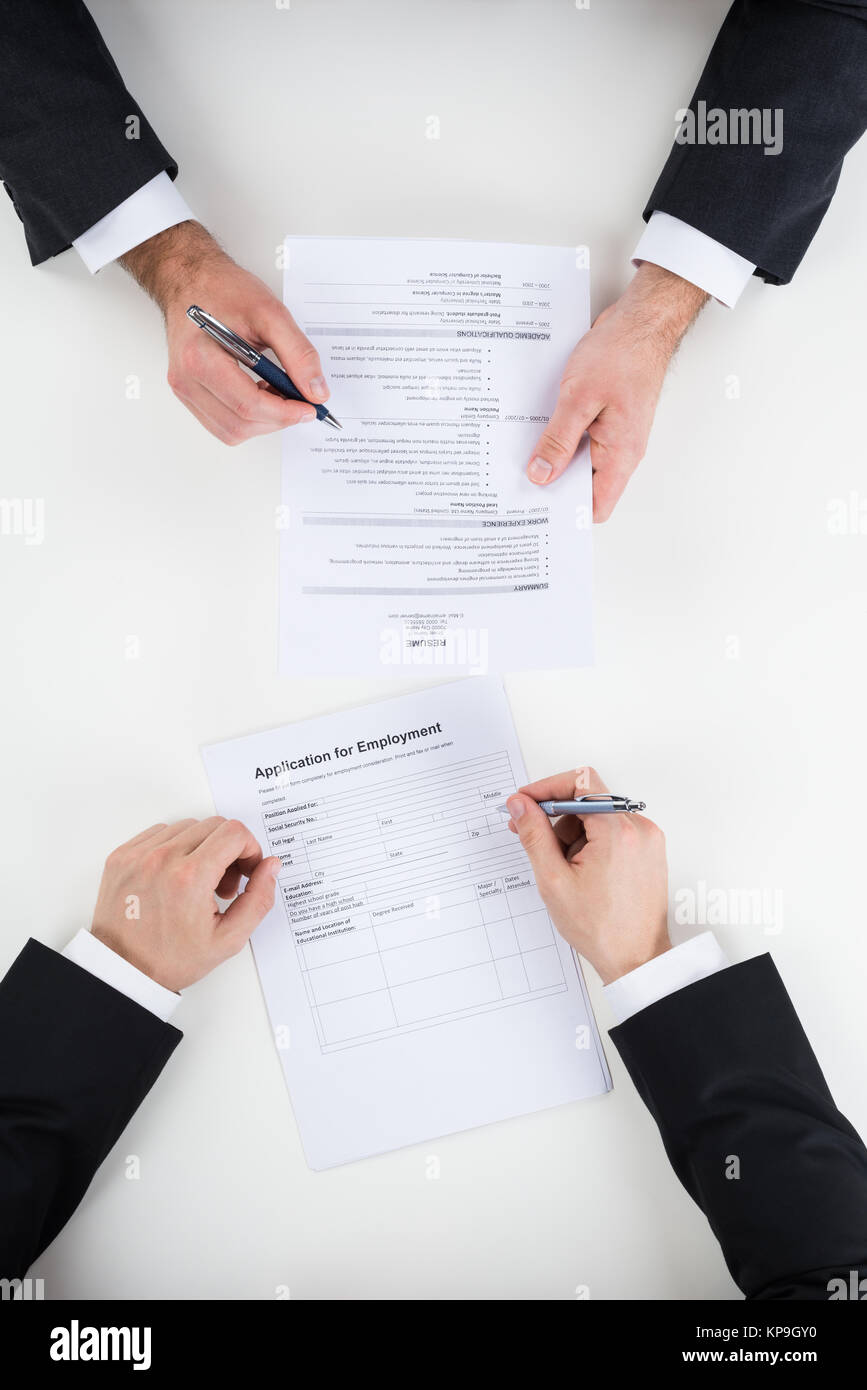 Businessman Taking Interview Of Candidate At Desk Stock Photo - Alamy