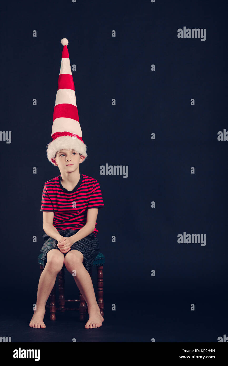 Young boy in a red and white striped dunce cap Stock Photo - Alamy