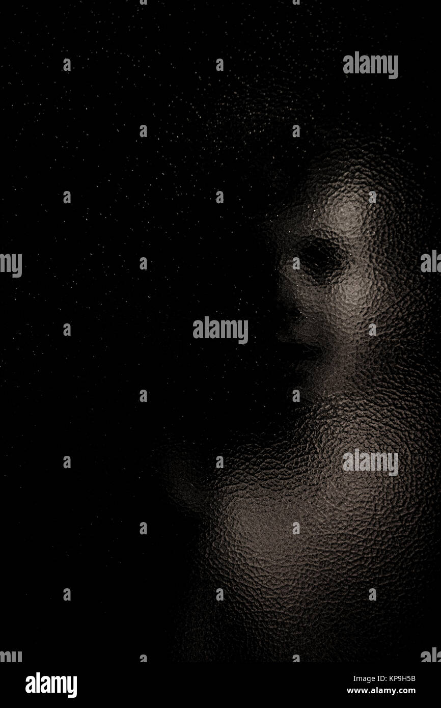 Silhouette Young Boy Behind a Textured Glass Stock Photo - Alamy