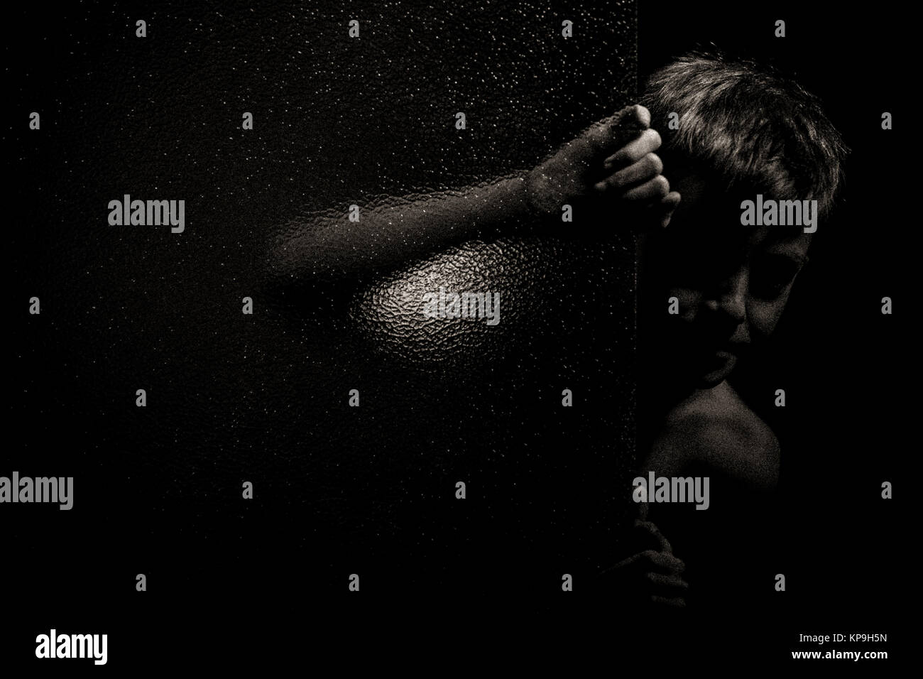 Silhouette Boy Peeking From Behind a Glass Wall Stock Photo - Alamy