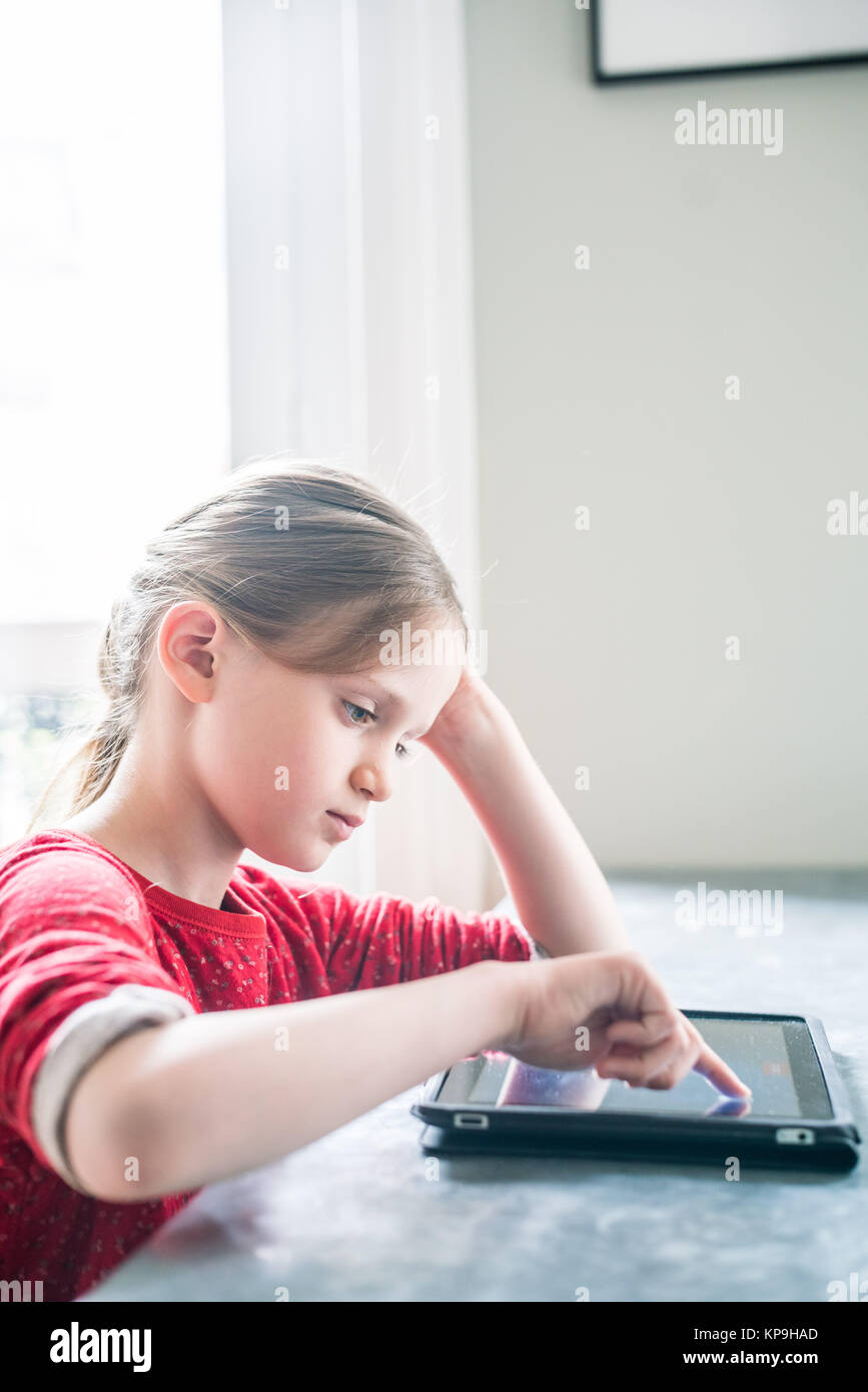 7 year-old girl using tablet computer Stock Photo - Alamy