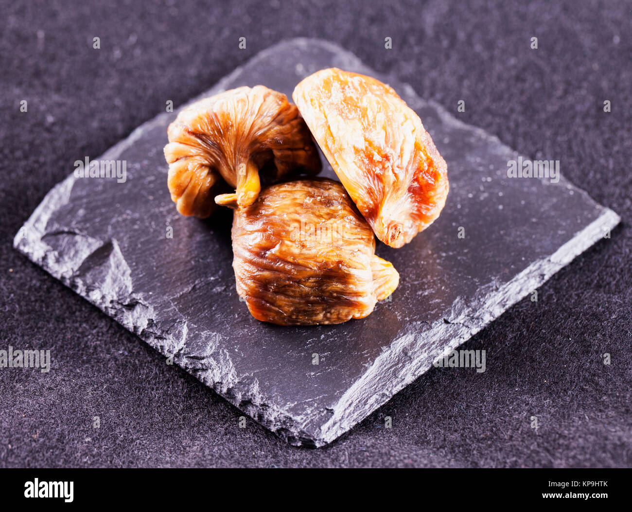 Dried figs over stone Stock Photo - Alamy