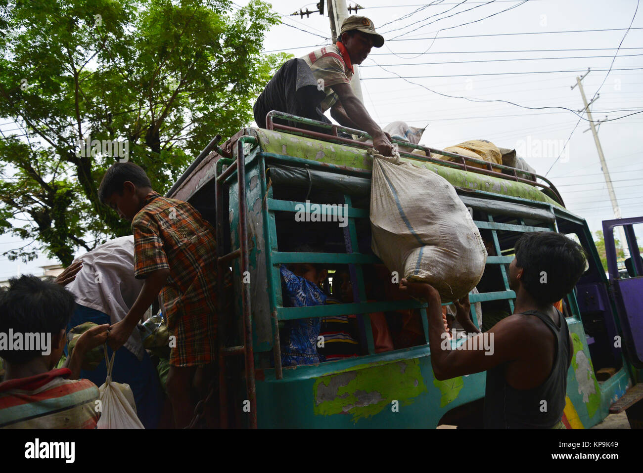 Rohingya refugees are rising in a mini-truck before being shift to a ...