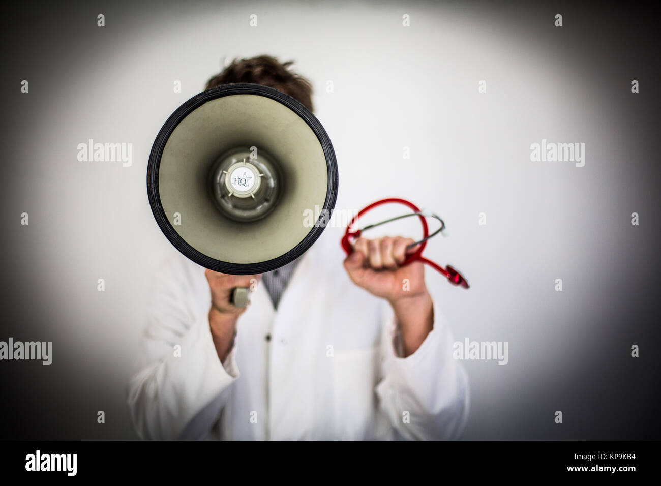 Doctor using megaphone Stock Photo - Alamy