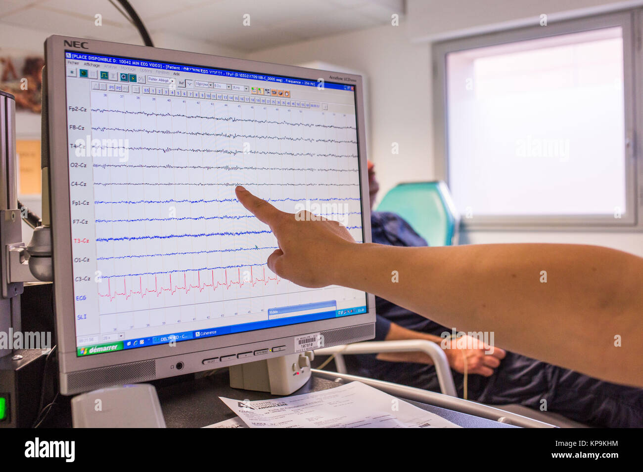 Man undergoing an electroencephalogram (EEG), epilepsy screening ...